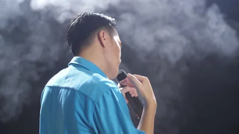 Back View Of A Man Holding A Microphone ... | Stock Video | Pond5