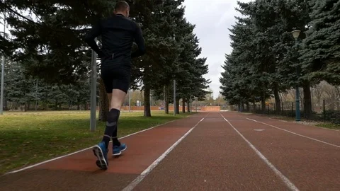 Back view of man jogging in slow motion ... | Stock Video | Pond5