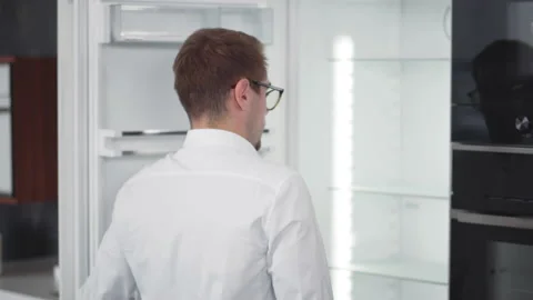 Back view of man look into empty refrige... | Stock Video | Pond5