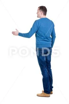 Back view of man in movement reaches out to shake hands. back view of ...