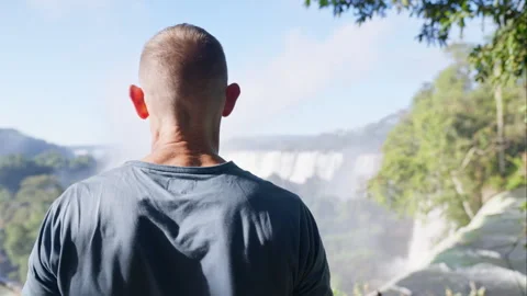 Back View Of A Man Observing Waterfalls | Stock Video | Pond5