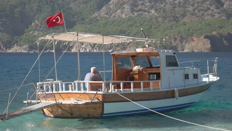 Back view of man sitting at fishing boat... | Stock Video | Pond5