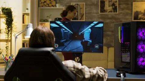 Back view of man sitting on gaming chair... | Stock Video | Pond5