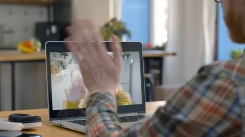 Back view of man video calling to mature... | Stock Video | Pond5
