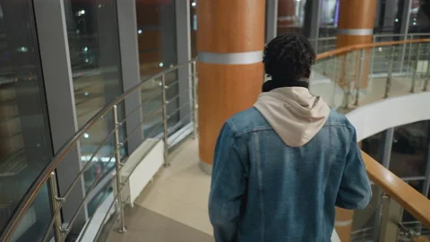 Back view of man walking inside modern b... | Stock Video | Pond5