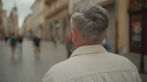 Back view of a man walking with other pe... | Stock Video | Pond5