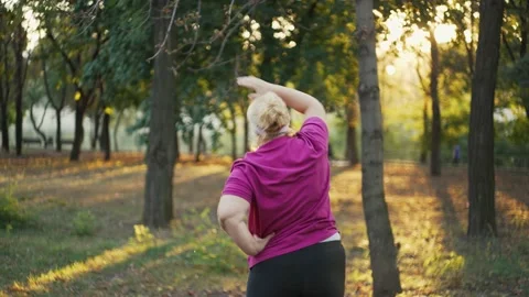 Back view of obesse woman doing exercise... | Stock Video | Pond5