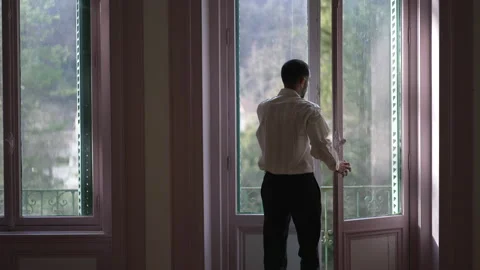 Back view of person opening large window... | Stock Video | Pond5