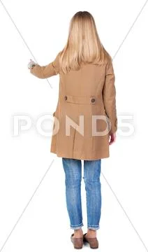 Back view of pointing womanin brown cloak ~ Premium Photo #66451564