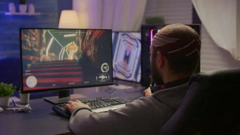 Back view of pro man gamer sitting on ga... | Stock Video | Pond5