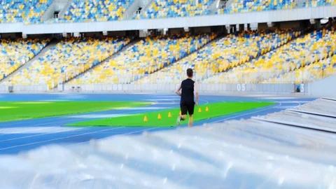 back view of runner running at stadium | Stock Video | Pond5