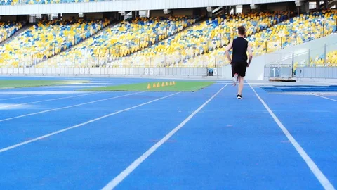 back view of runner running at stadium | Stock Video | Pond5