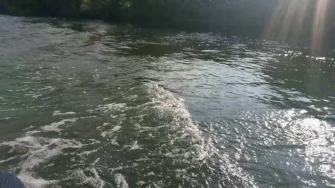 Back view from side of moving boat wave ... | Stock Video | Pond5