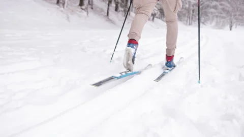 Back view of a skier wearing yellow jack... | Stock Video | Pond5