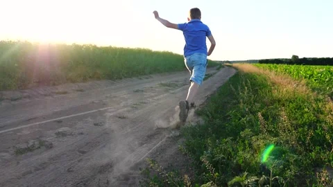Back view to small boy running on dry gr... | Stock Video | Pond5