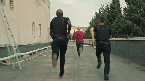 Back view of Suspect running away from t... | Stock Video | Pond5