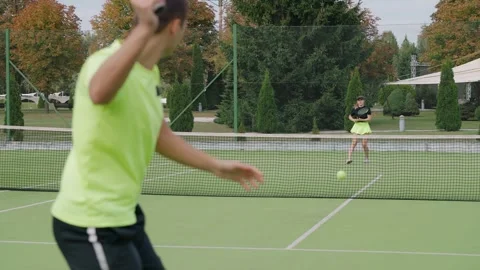 Back view of tennis player hits the ball... | Stock Video | Pond5