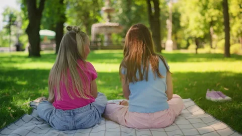 Back view of two little sisters sitting ... | Stock Video | Pond5
