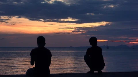Back view of two teen boys silhouettes a... | Stock Video | Pond5