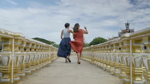 Back View Of Two Women Walking On The Br... | Stock Video | Pond5