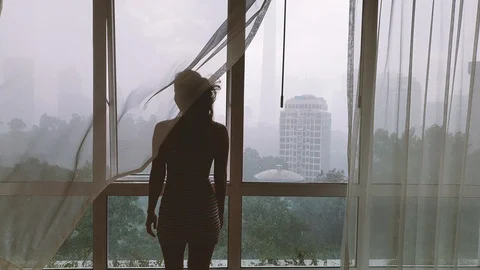 Back view of woman looking through windo... | Stock Video | Pond5