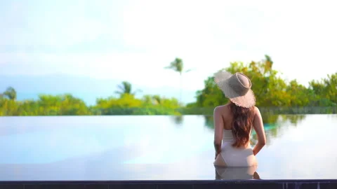 Back view of the woman sitting on the ed... | Stock Video | Pond5
