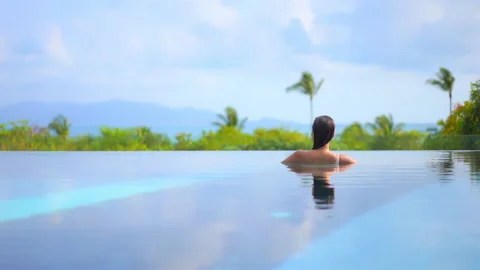 Back view of woman swimming inside pool ... | Stock Video | Pond5