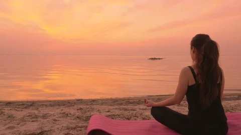 Back view of the yoga practice by the me... | Stock Video | Pond5