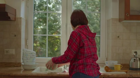 Back view of young adult woman washing d... | Stock Video | Pond5