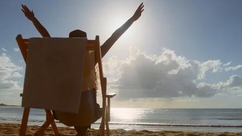 Back view of young beautiful woman sunba... | Stock Video | Pond5