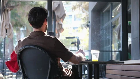 Back view of young man smoking tobacco c... | Stock Video | Pond5
