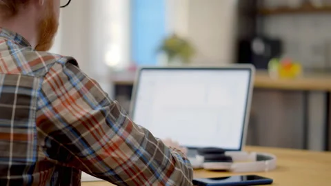 Back view of young man using laptop sitt... | Stock Video | Pond5