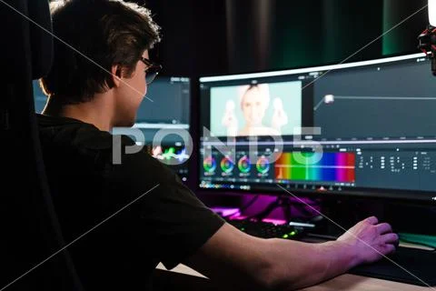 Back view of a young white man video editor Stock Photo #158889235