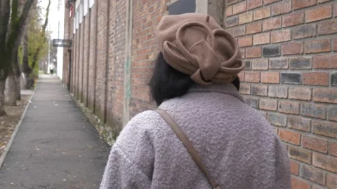 Back view. A young woman in a beret walk... | Stock Video | Pond5