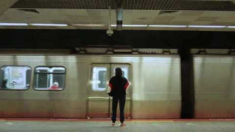Back view of young woman waiting for sub... | Stock Video | Pond5