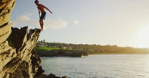 Backflip Cliff Jumping into the Ocean | Stock Video | Pond5