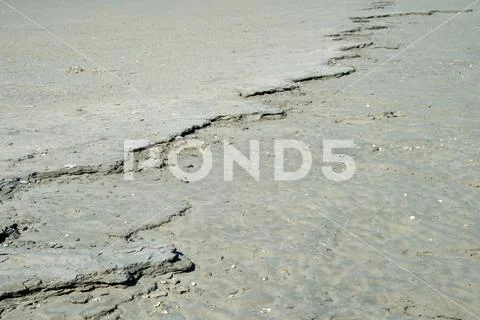 Backgrounds. Close up of a crack in a sandy surface Stock Image #219746546