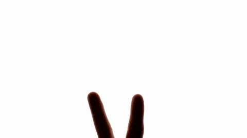 Backlit silhouette of a hand holding up ... | Stock Video | Pond5