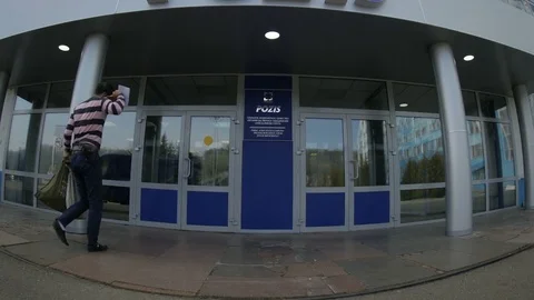 Backside View Man Comes into Building wi... | Stock Video | Pond5