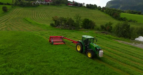 Backwards aerial tracking of tractor wit... | Stock Video | Pond5