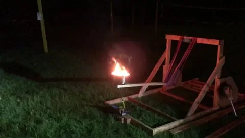 Backyard Catapult Launches Flames Skywar... | Stock Video | Pond5