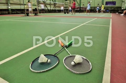Badminton - two shuttlecocks on rackets in the badminton courts with ...