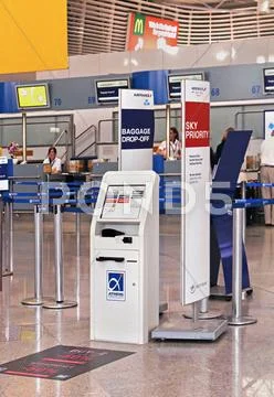 Baggage drop off and check in at Athens airport with staff behind ...