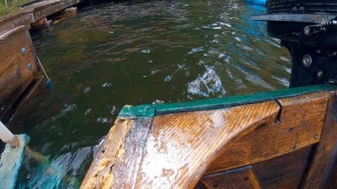 Bailing water over transom on small wood... | Stock Video | Pond5