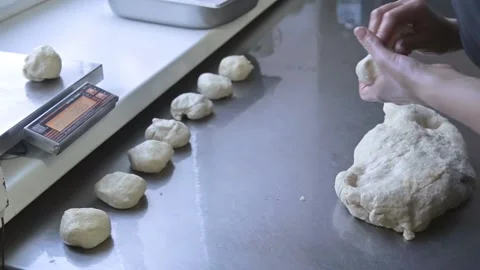 baker divides the dough into portions an... | Stock Video | Pond5