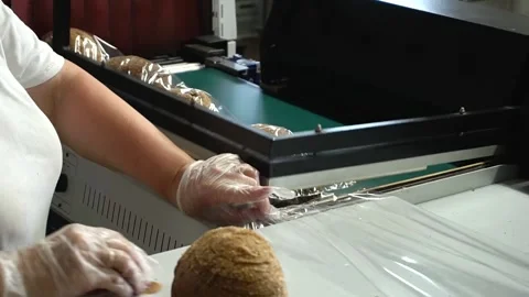 bakery worker packs sliced bread u... | Stock Video | Pond5