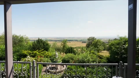 Balcony view of green fields with mounta... | Stock Video | Pond5
