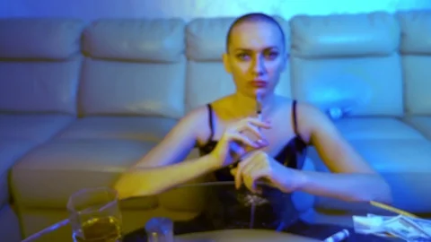 A bald addict lady dealer offers a syrin... | Stock Video | Pond5