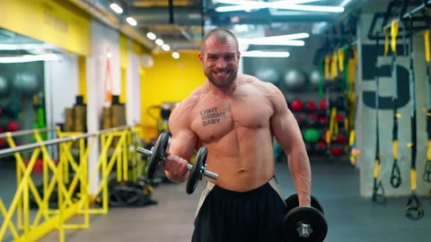 Bald bodybuilder exercising in the gym. ... | Stock Video | Pond5