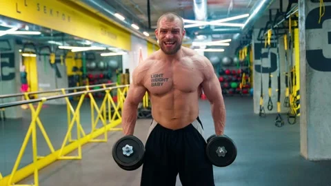 Bald bodybuilder exercising in the gym. ... | Stock Video | Pond5